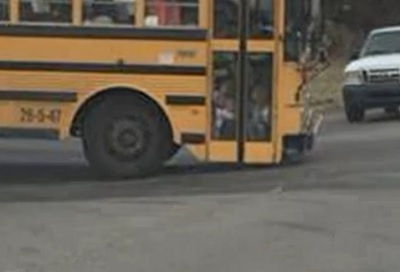 Students seen sitting on moving school bus steps | thv11.com